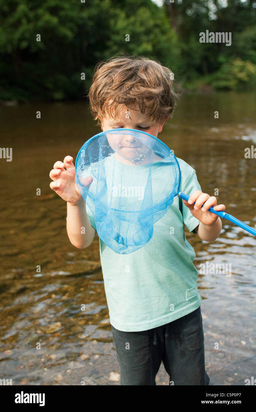Boy holding fishing net river hi-res stock photography and images - Alamy