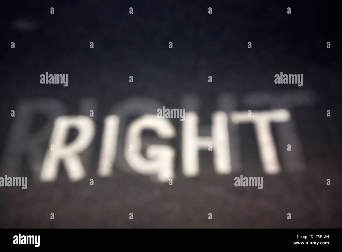 The word 'right' painted on street - shot out of focus and faint ...