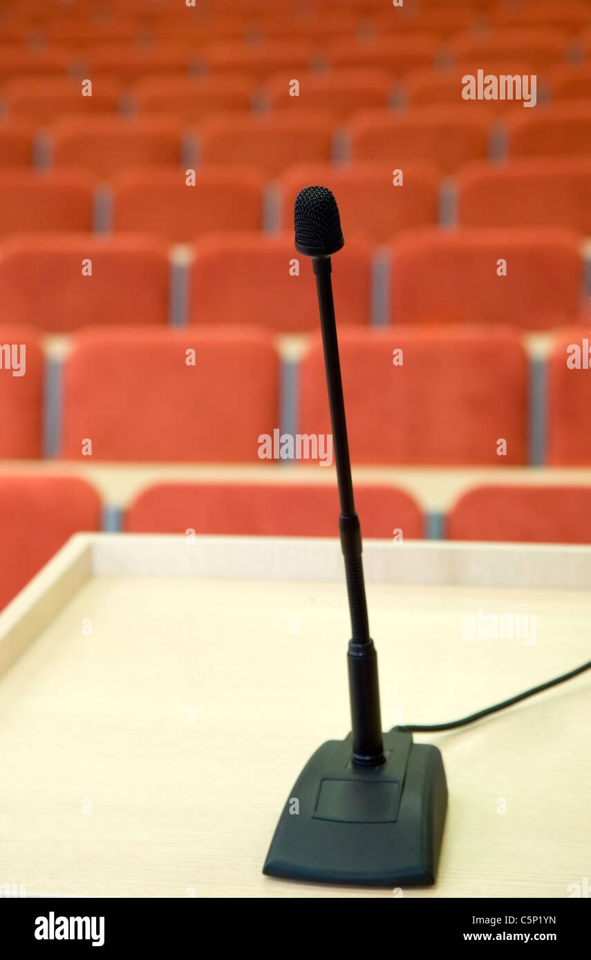Black microphone is standing against auditorium with red chairs Stock ...