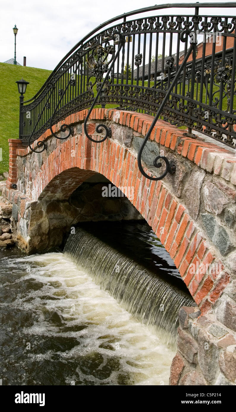 Stone bridge with metal fences over the river, nature and architecture ...
