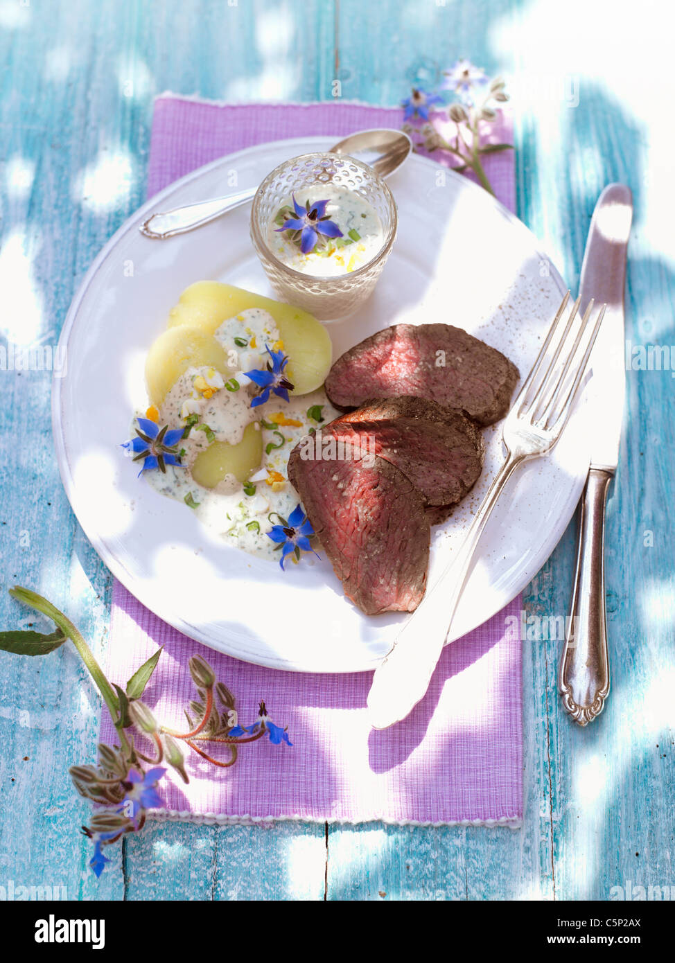 Poached fillet of beef with herbs and borage Stock Photo - Alamy