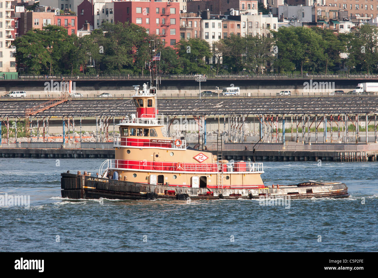 Tugboat "Jill Reinauer" heads north on the East River in New York City ...
