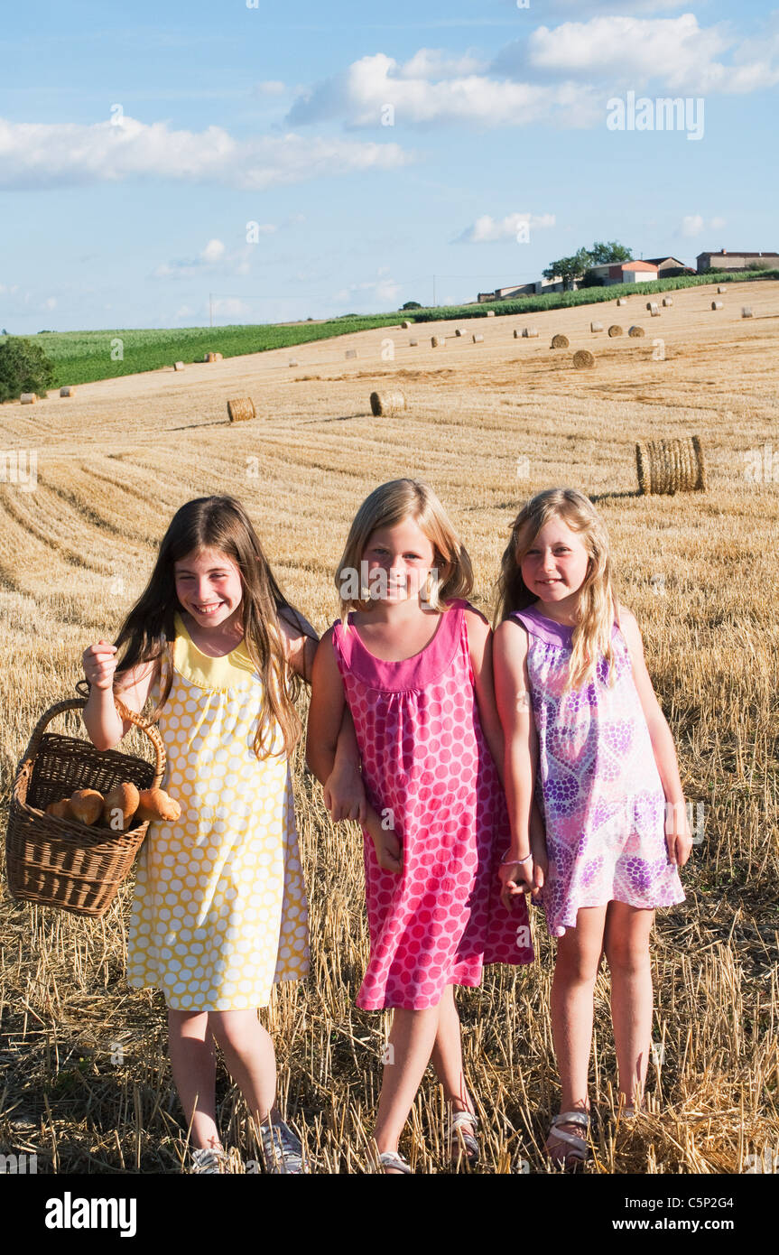 Three girls standing in field, portrait Stock Photo - Alamy