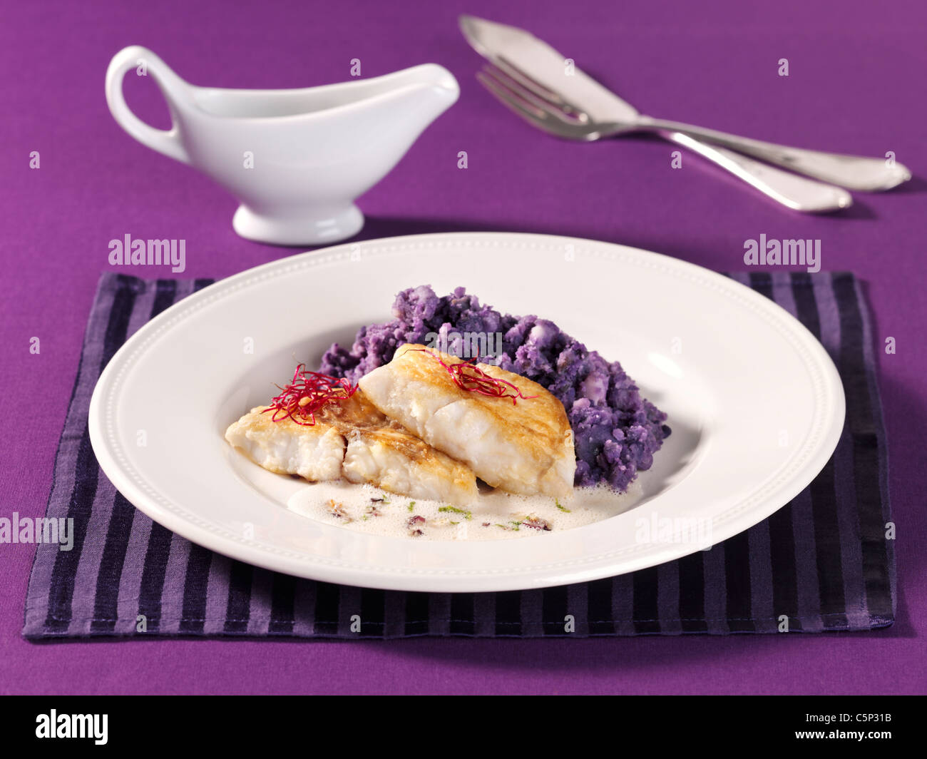 Braised fish fillet with white chocolate sauce and mashed violett ...