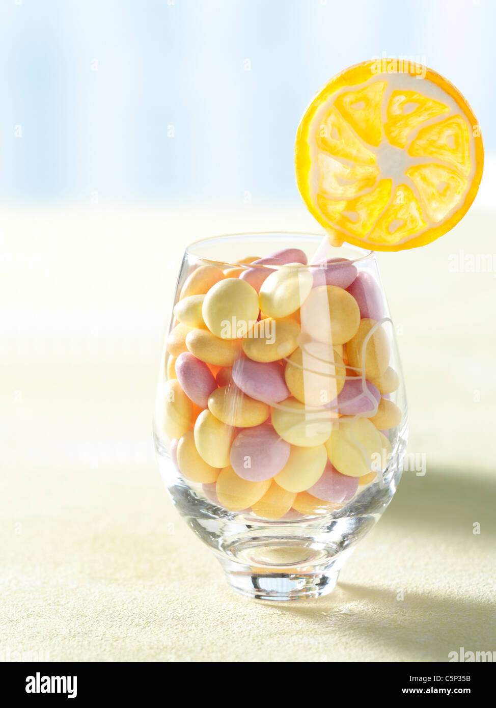 Mixed drops with an orange lollipop in a glass Stock Photo - Alamy