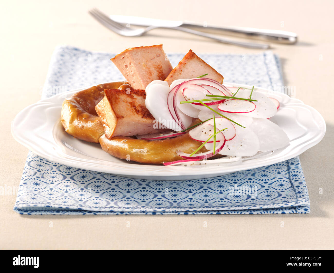 Bavarian Leberkaes with salad of radish and pretzel Stock Photo - Alamy