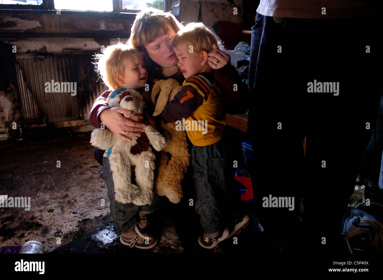 Family comfort each other after their house had been wrecked by fire ...