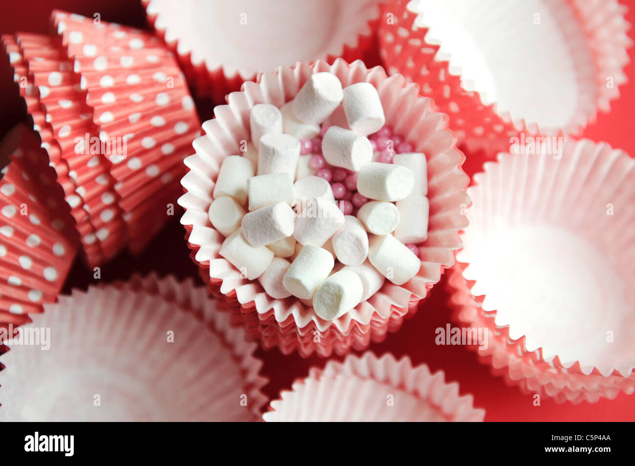 Pink Muffin cases with white dots and mini marshmallows Stock Photo - Alamy