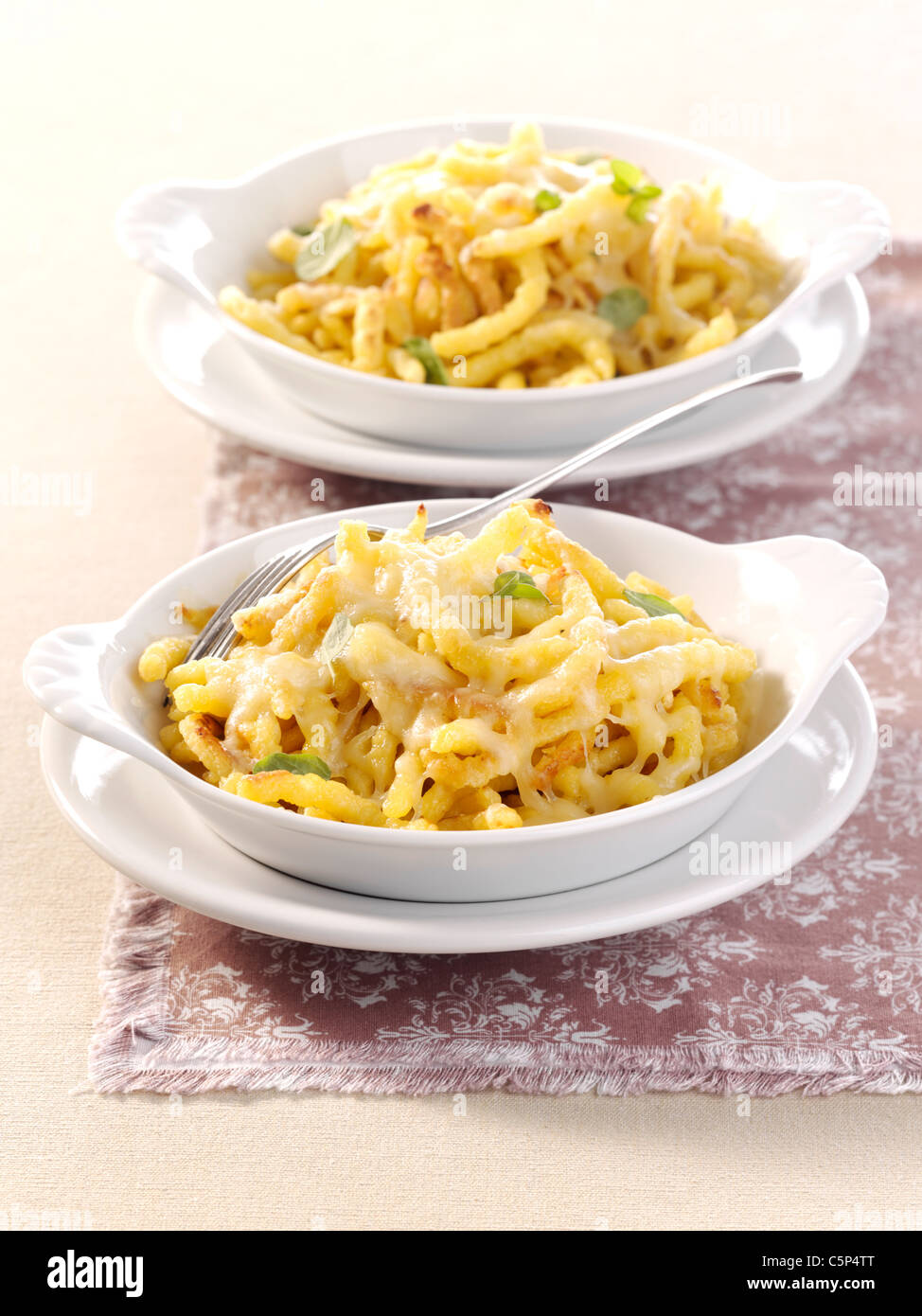 Spätzle pasta gratinated with cheese Stock Photo - Alamy