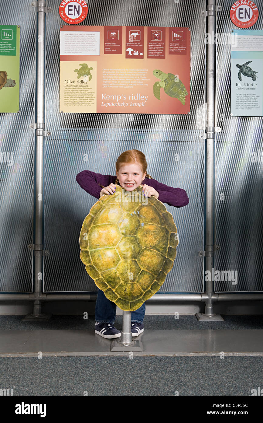 Girl standing behind kemps ridley sea turtle shell Stock Photo - Alamy