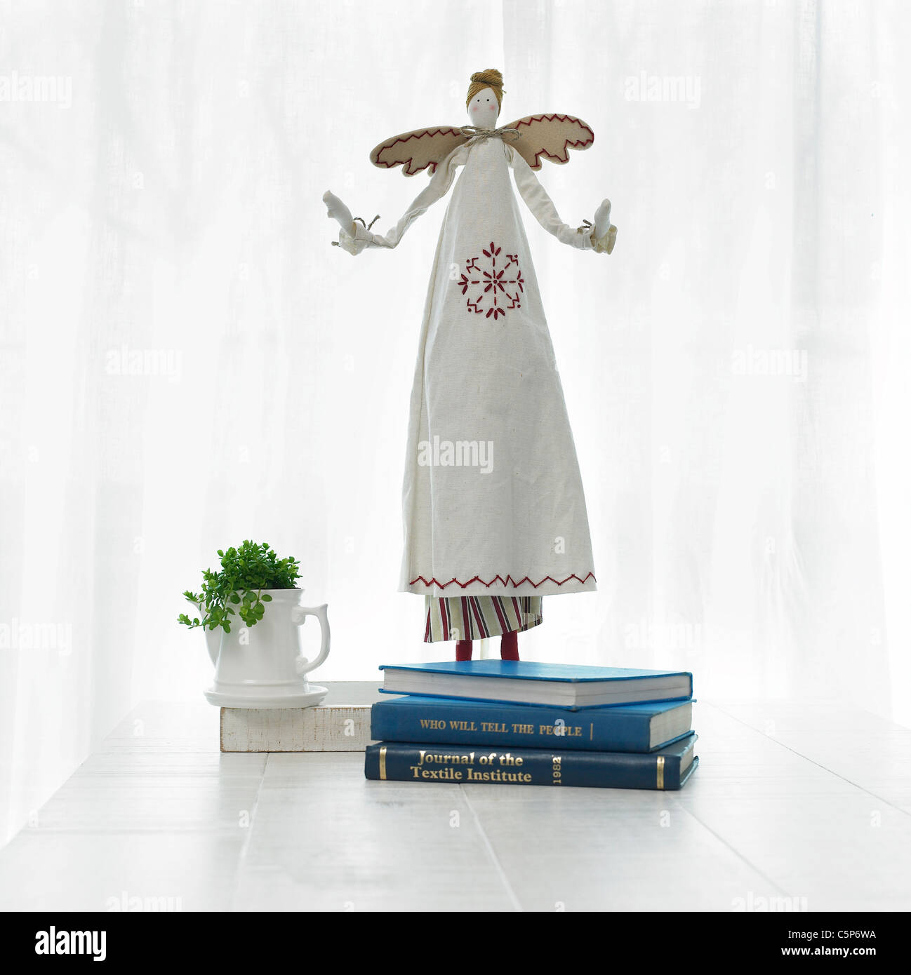 A doll and books on the table Stock Photo - Alamy