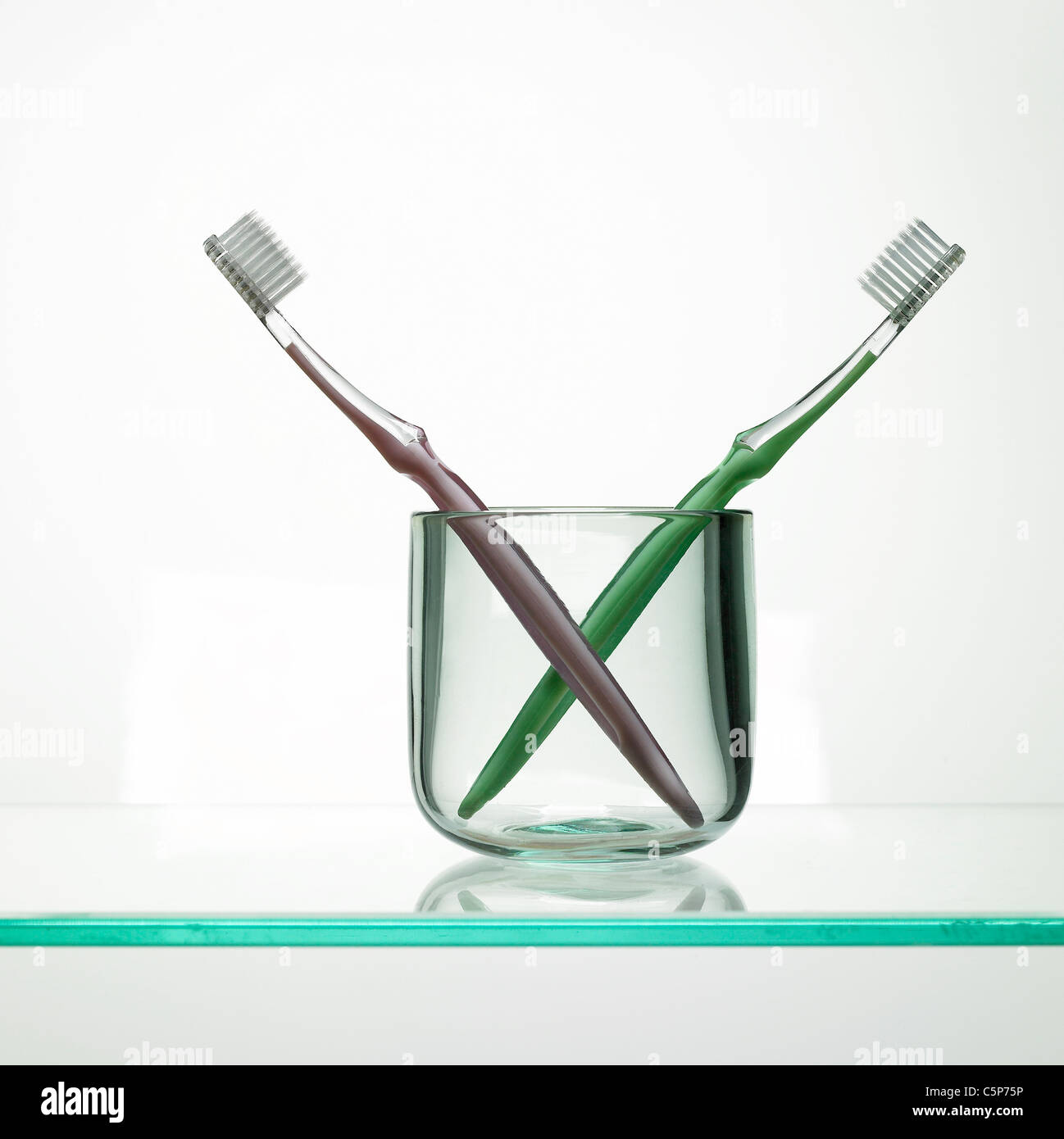Toothbrushes in the glass cup Stock Photo - Alamy