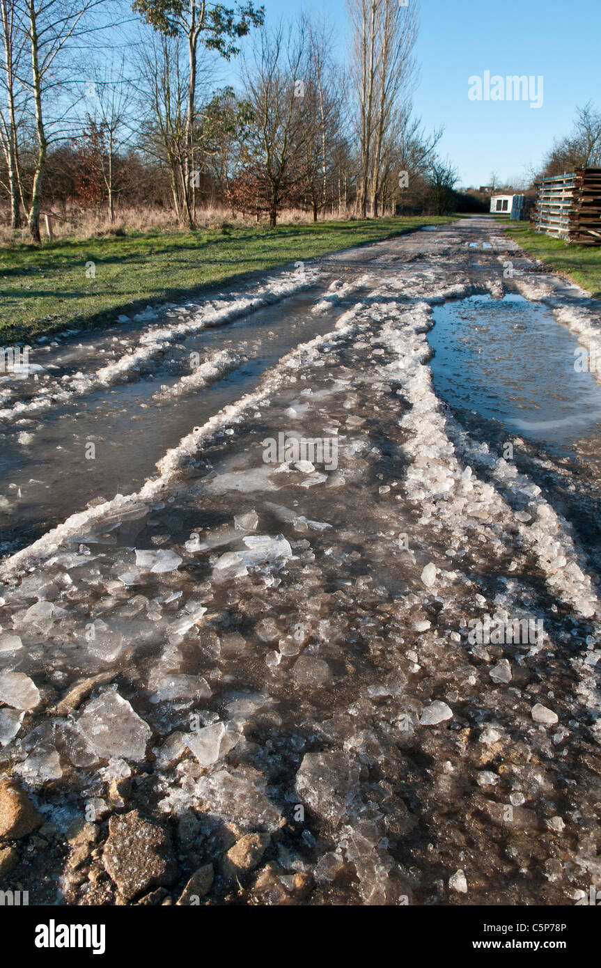 Ice on frozen road Stock Photo - Alamy
