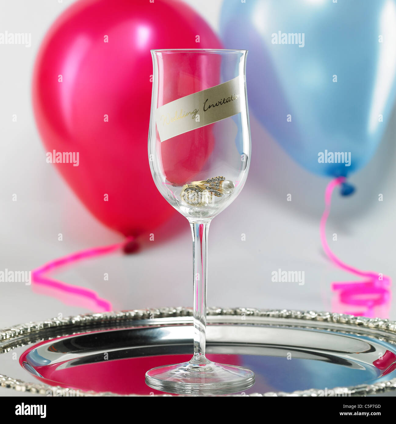 Wedding rings inside a glass Stock Photo - Alamy
