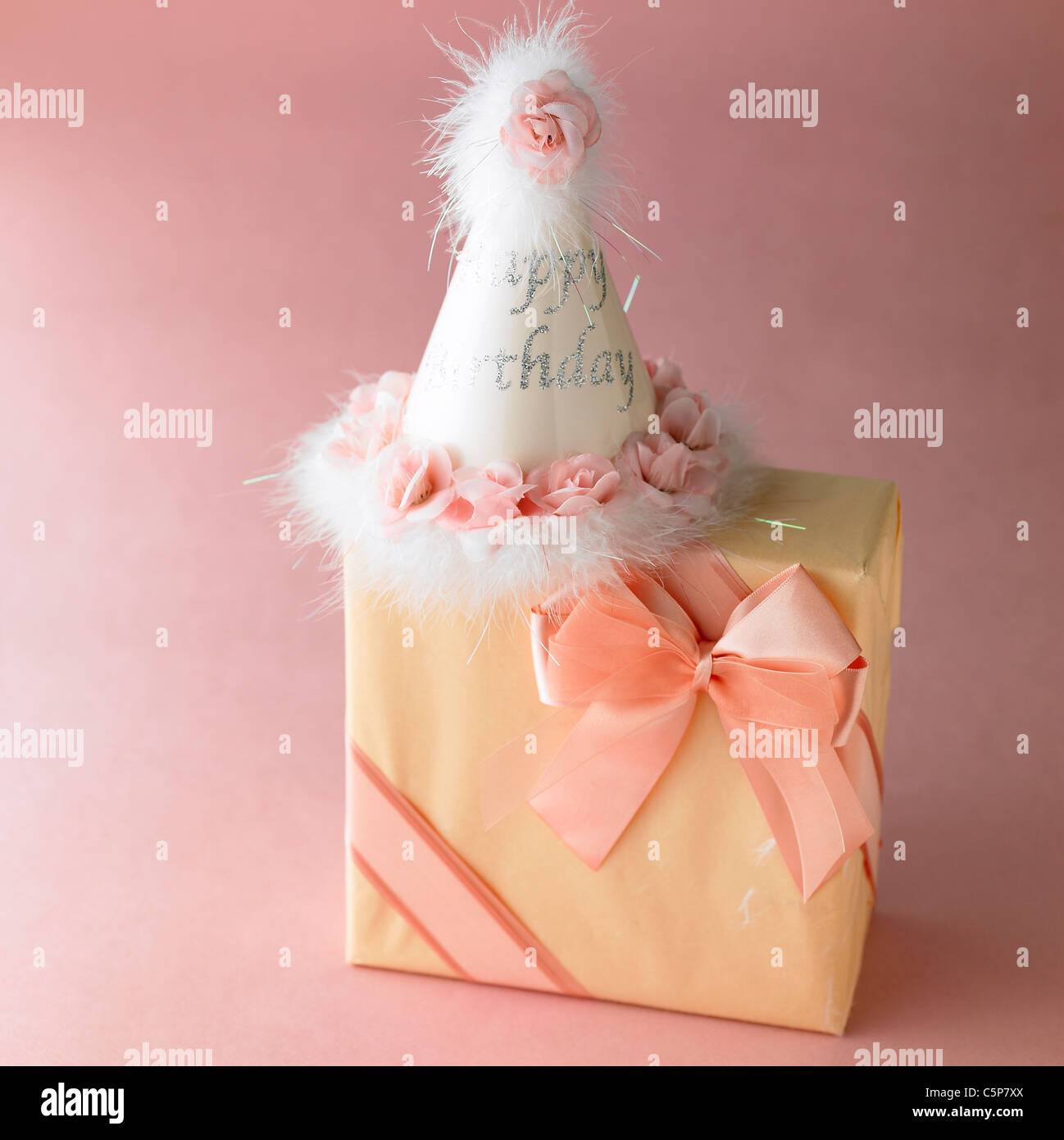 A party hat and a present Stock Photo - Alamy