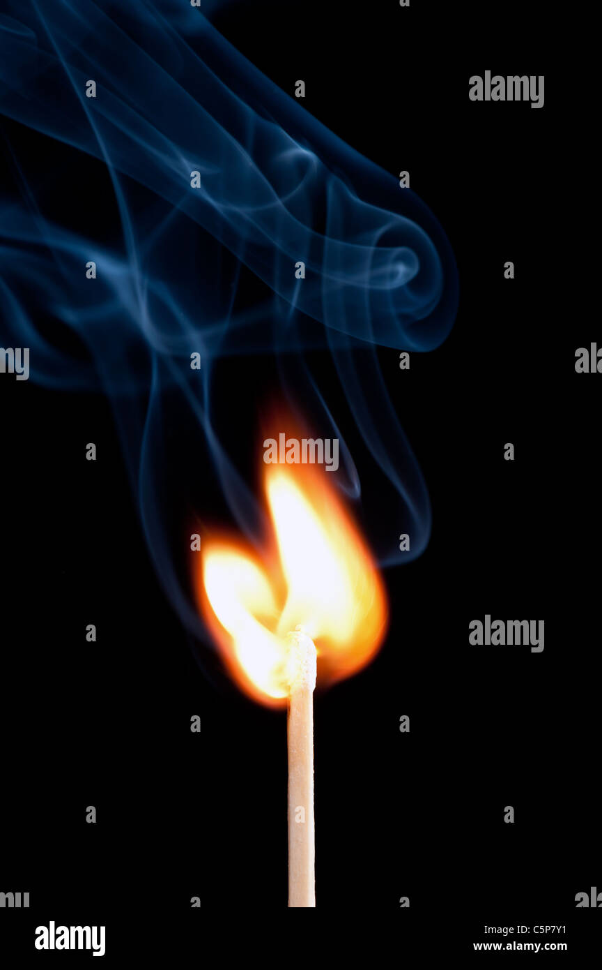 burning match with smoke on black background Stock Photo - Alamy