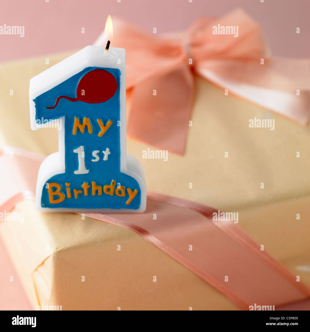 A present and a birthday candle Stock Photo - Alamy