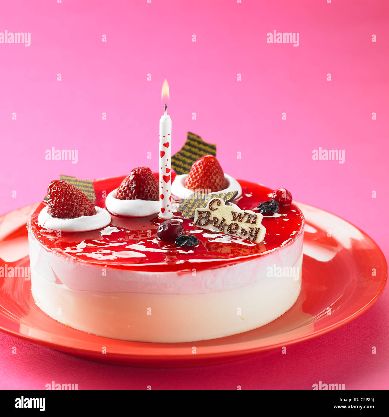 A cake with a candle on Stock Photo - Alamy