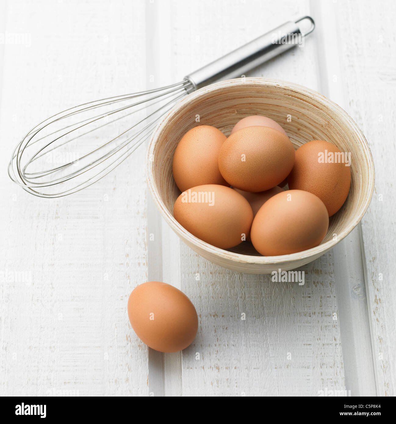 A balloon whisk and a bowl of eggs Stock Photo - Alamy