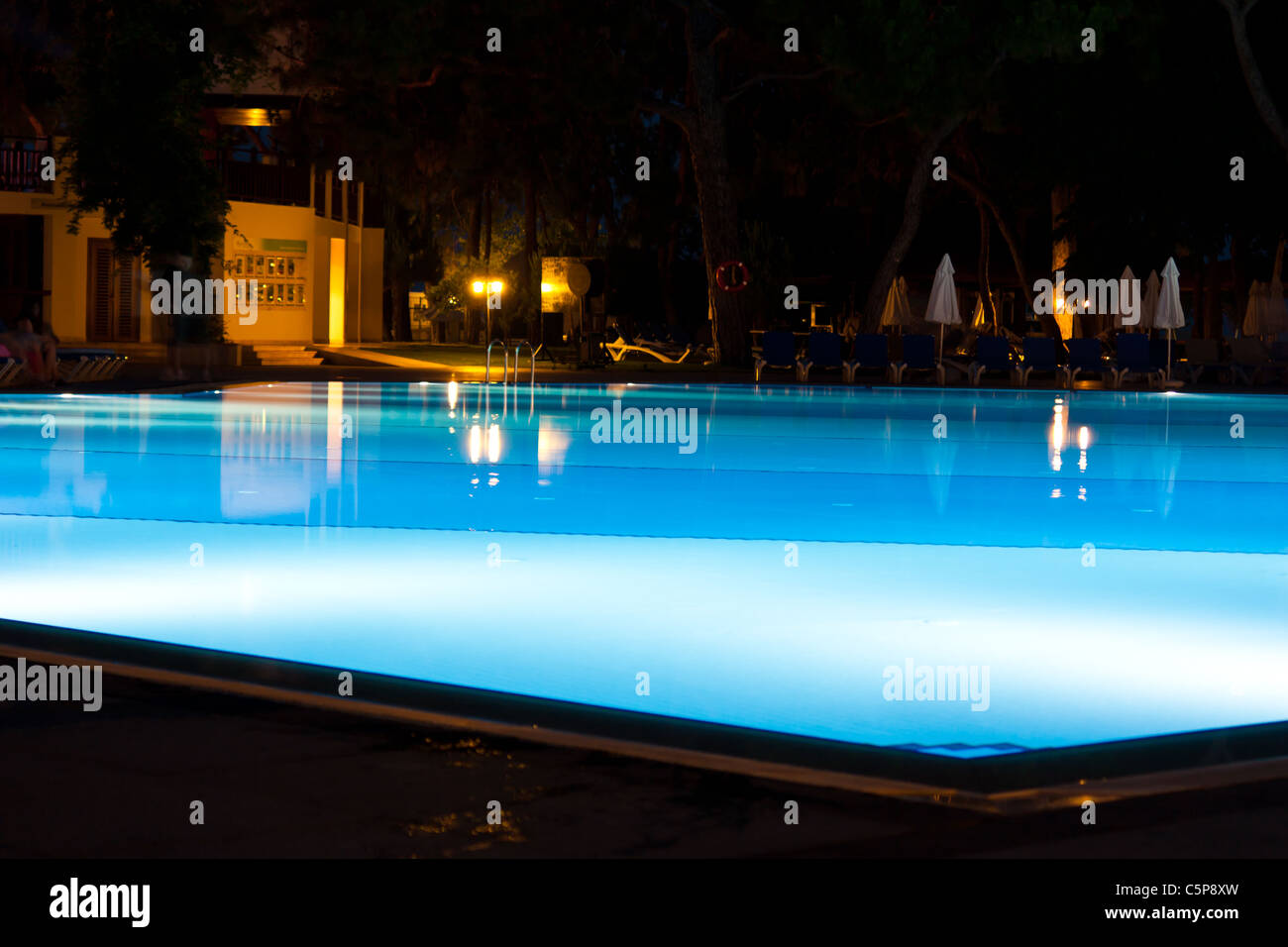 Hotel and resort swimming pool view at night Stock Photo - Alamy
