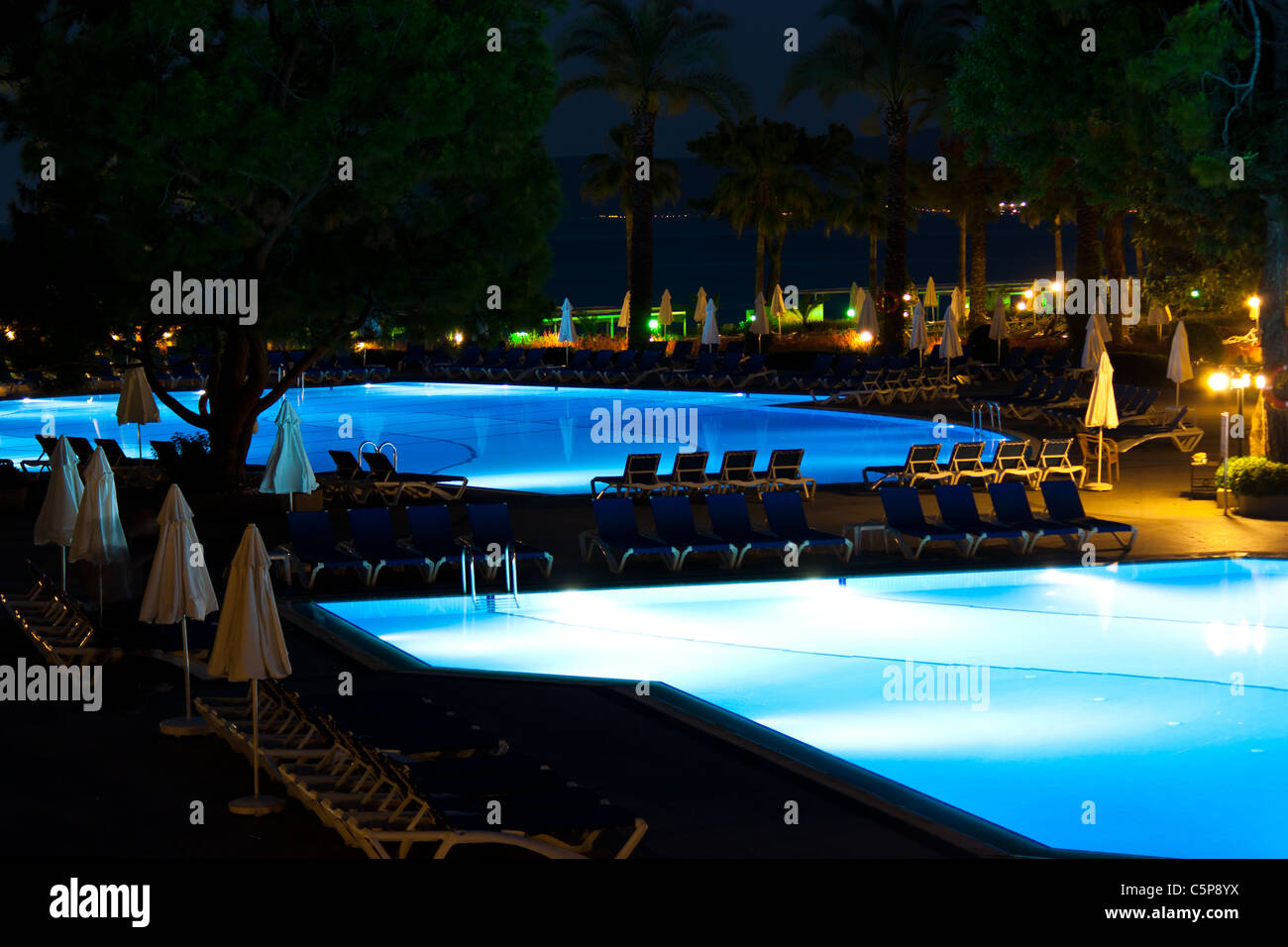 Hotel and resort swimming pool view at night Stock Photo - Alamy