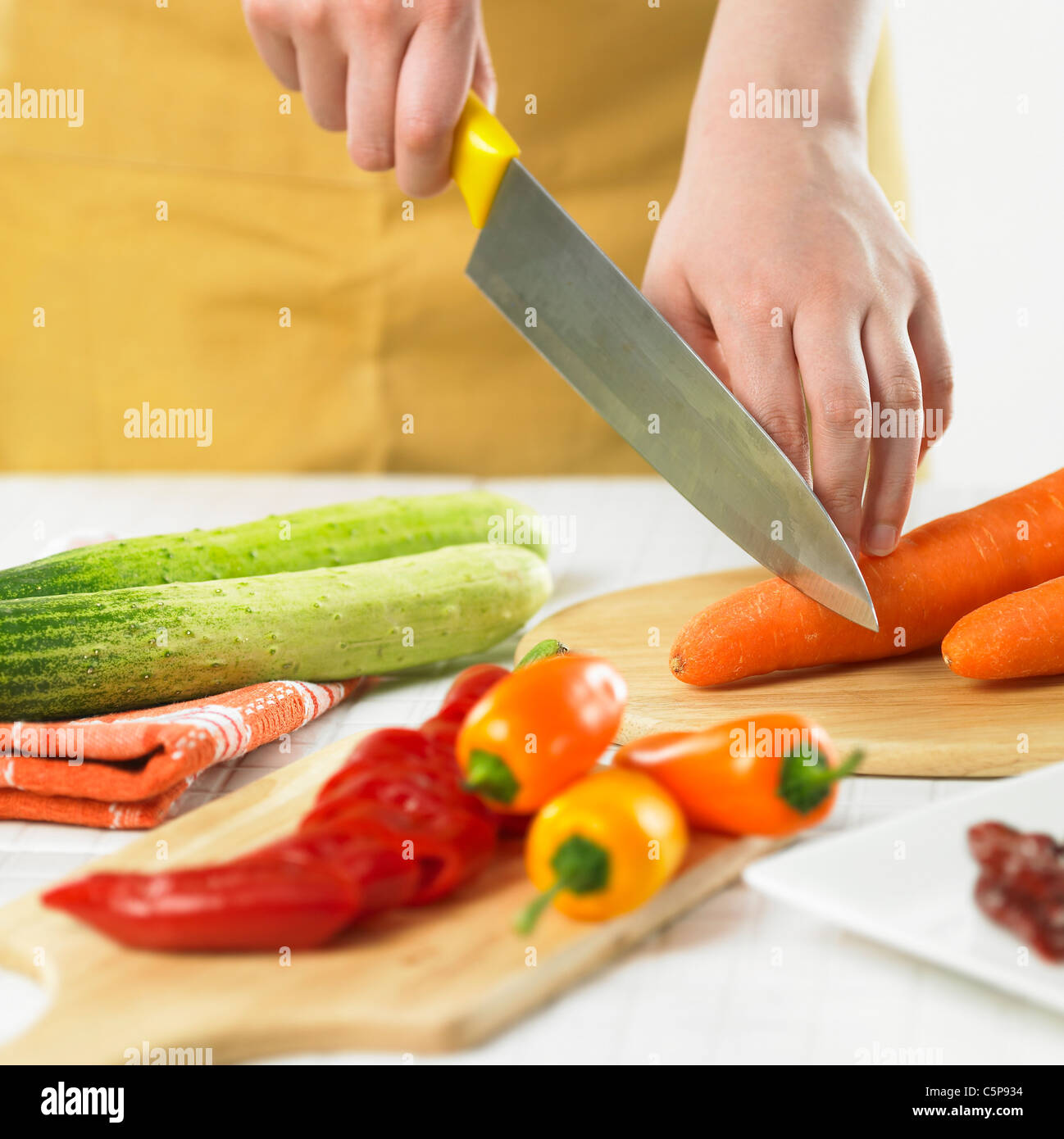 A person cutting a carrot Stock Photo - Alamy