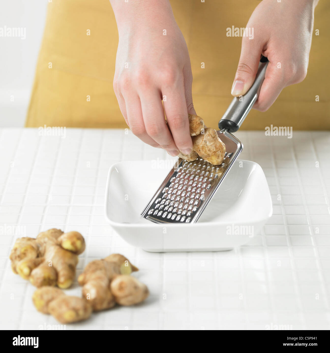 A person grating a ginger Stock Photo - Alamy