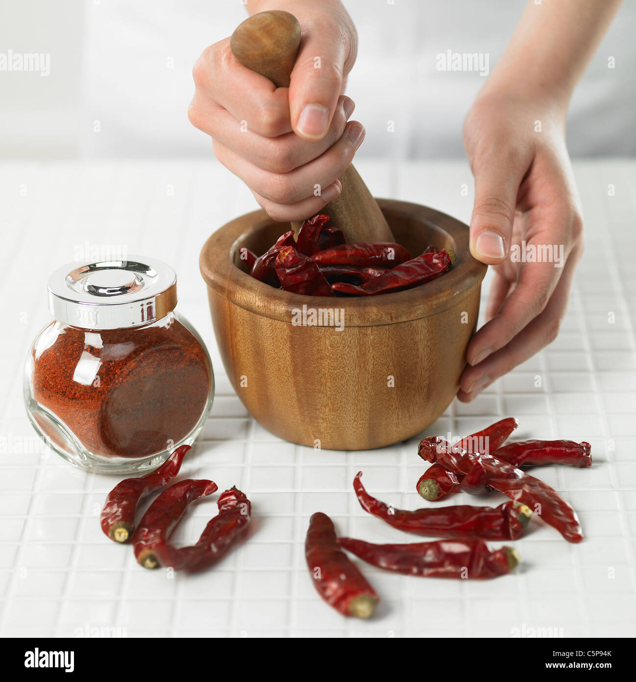 A person crushing chili Stock Photo - Alamy