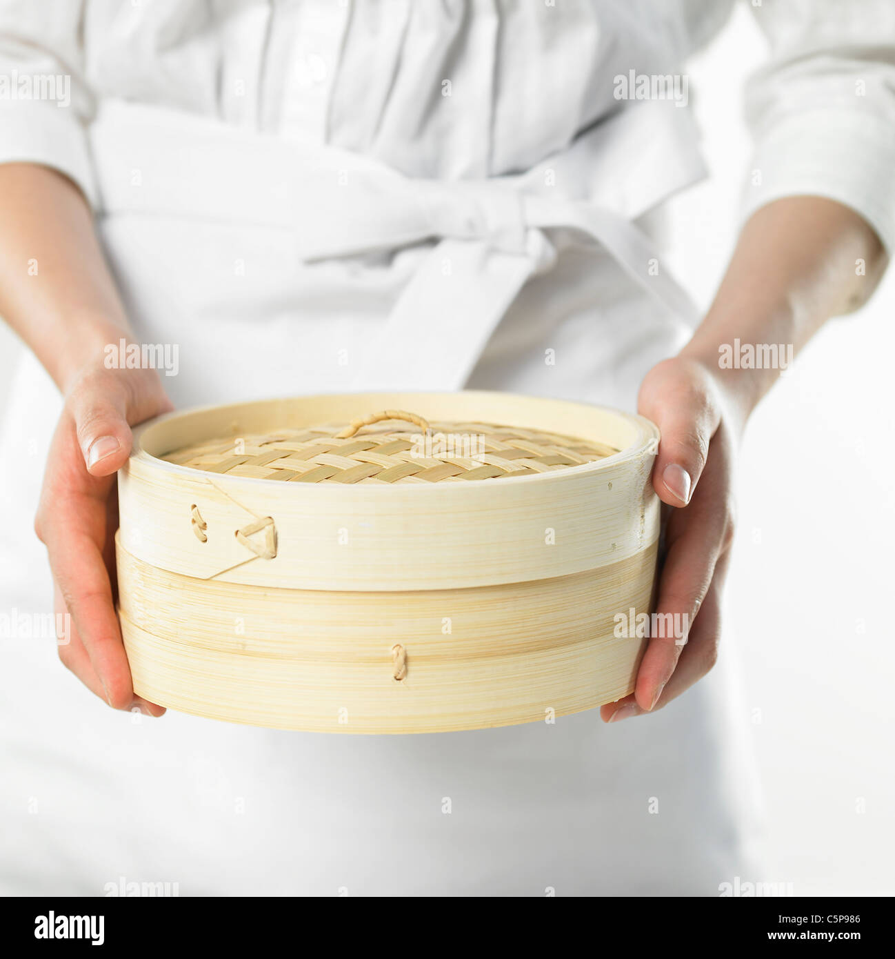 A person holding a container Stock Photo - Alamy