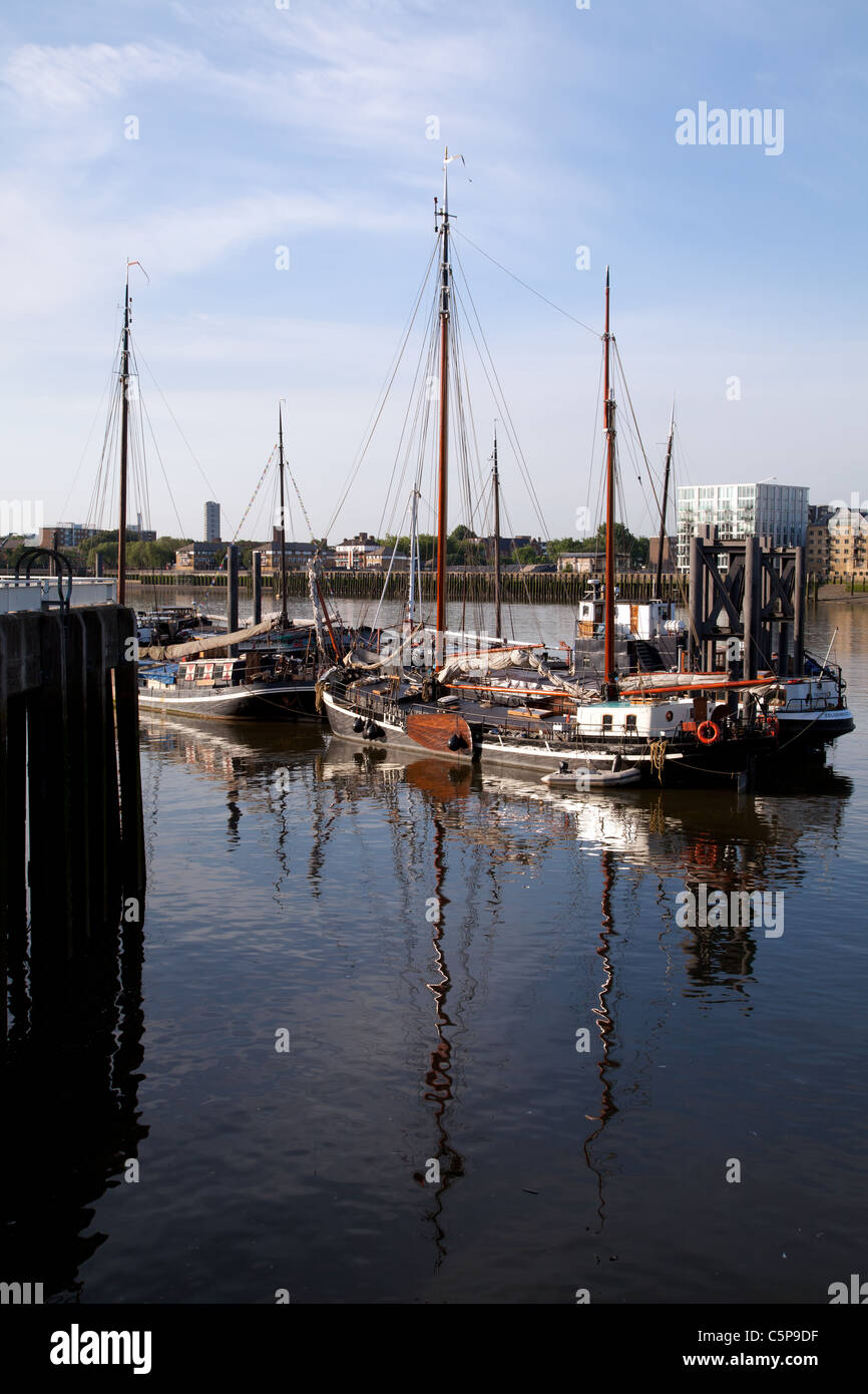 Traditional sailing barges reflected in the river Thames, Wapping Stock ...