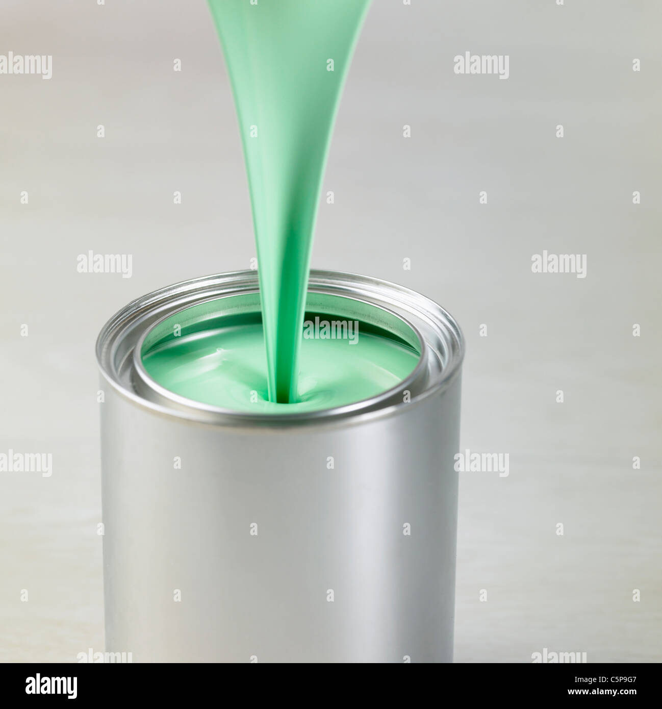 A paint pouring down to a can Stock Photo - Alamy