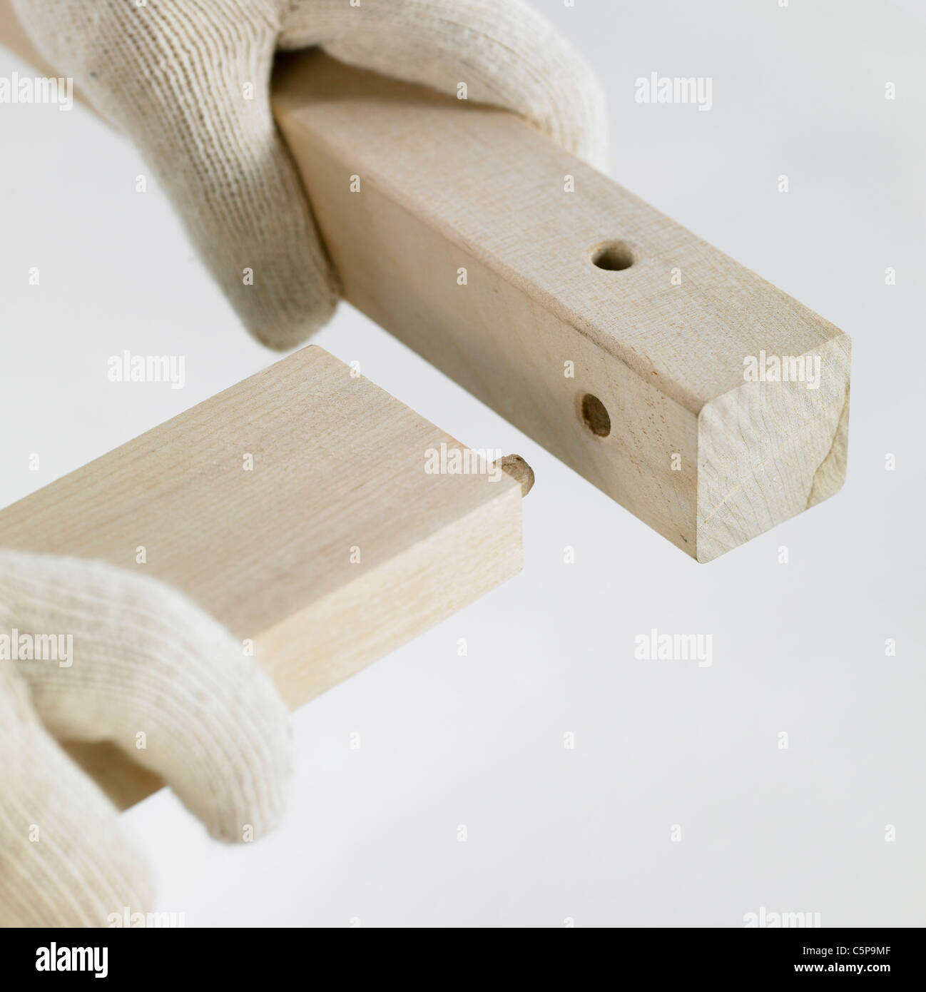 A person assembling wood pieces Stock Photo - Alamy