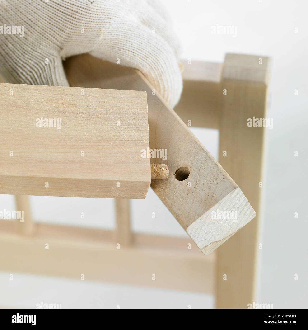 A person assembling wood pieces Stock Photo - Alamy