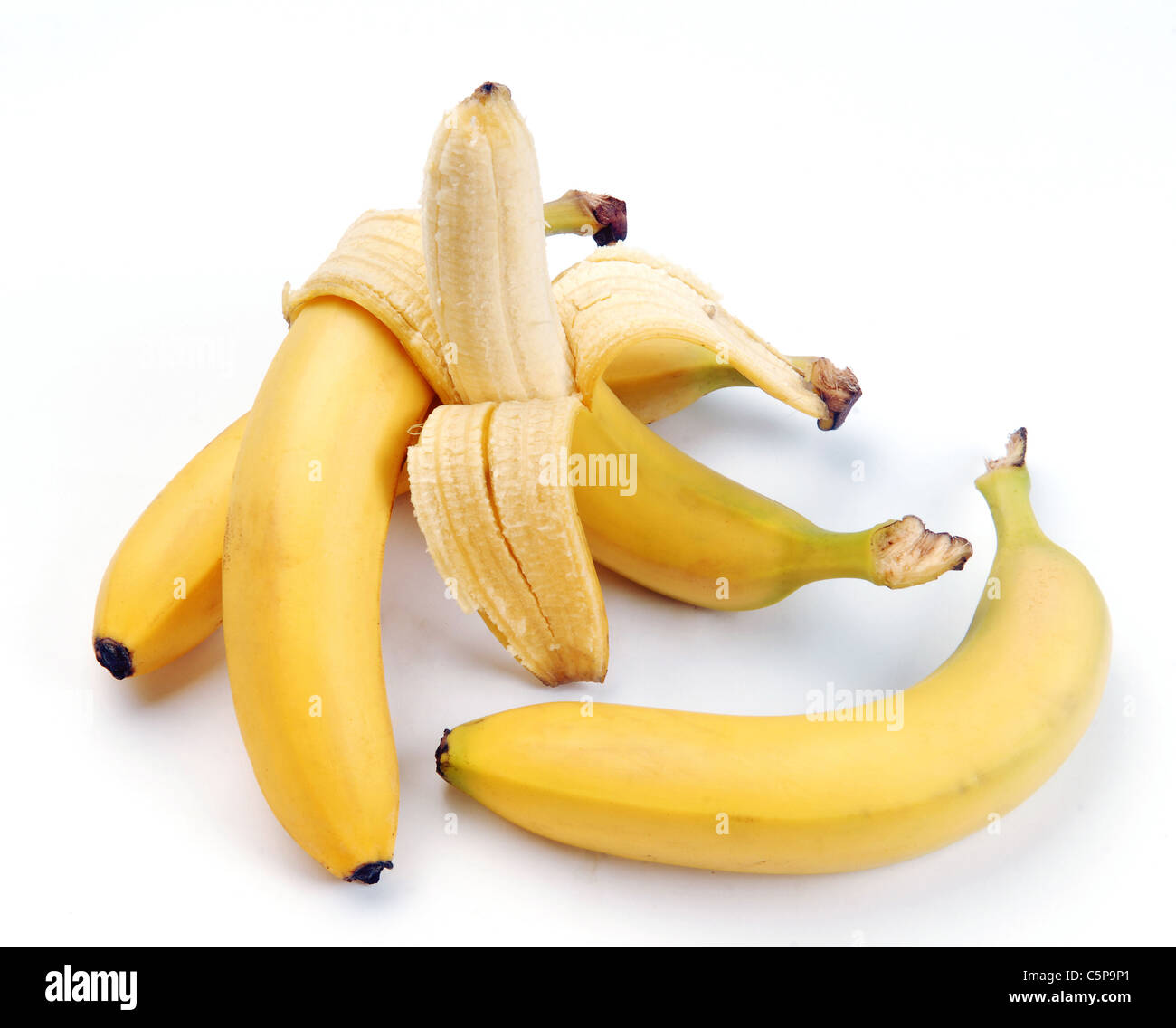 Ripe bananas and one half cleared on a white background Stock Photo - Alamy