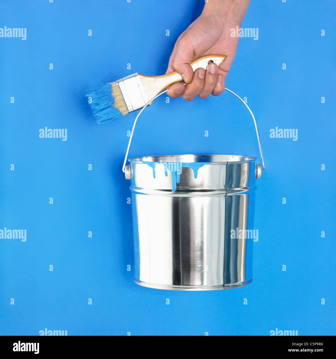 A person holding a paint bucket Stock Photo - Alamy