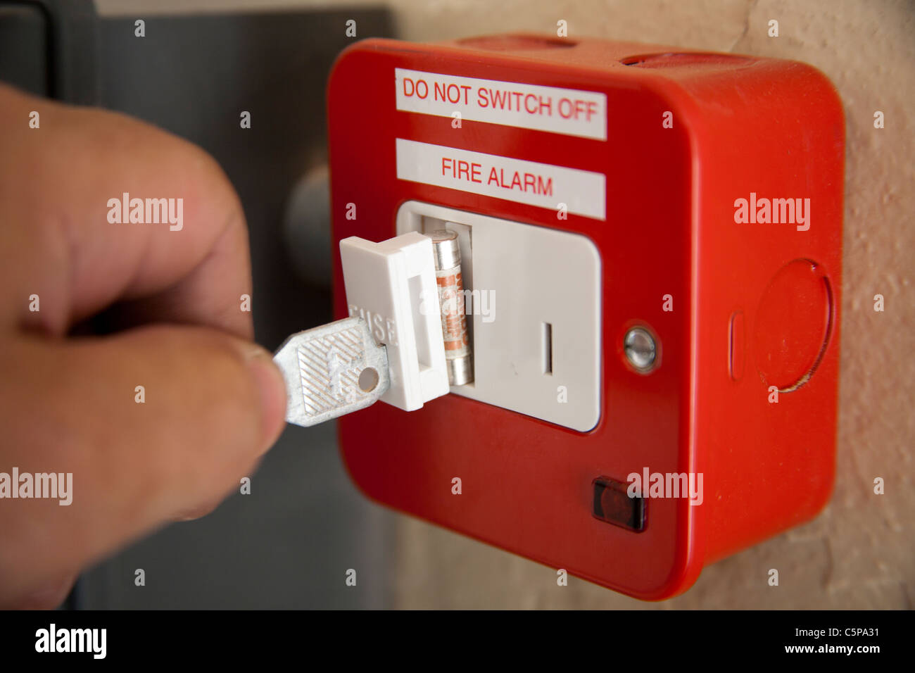 Qualified Electrician installing a Red fused keyswitch Stock Photo - Alamy
