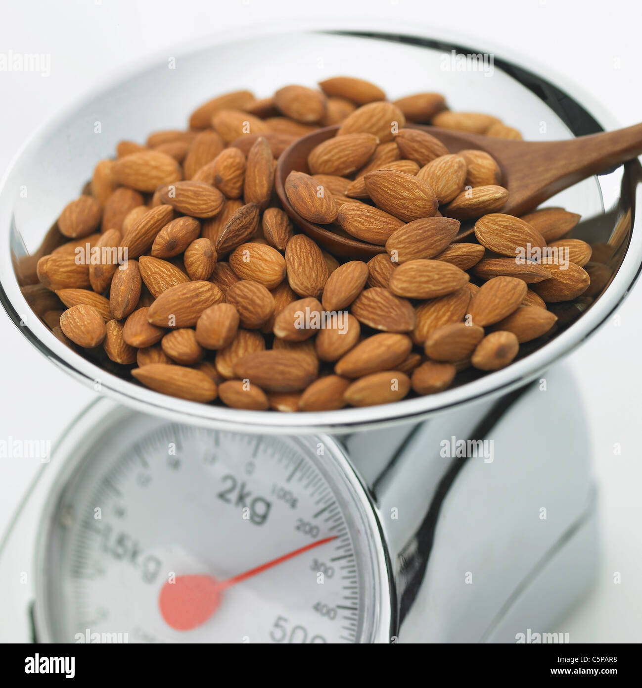 Almonds on a scale Stock Photo - Alamy