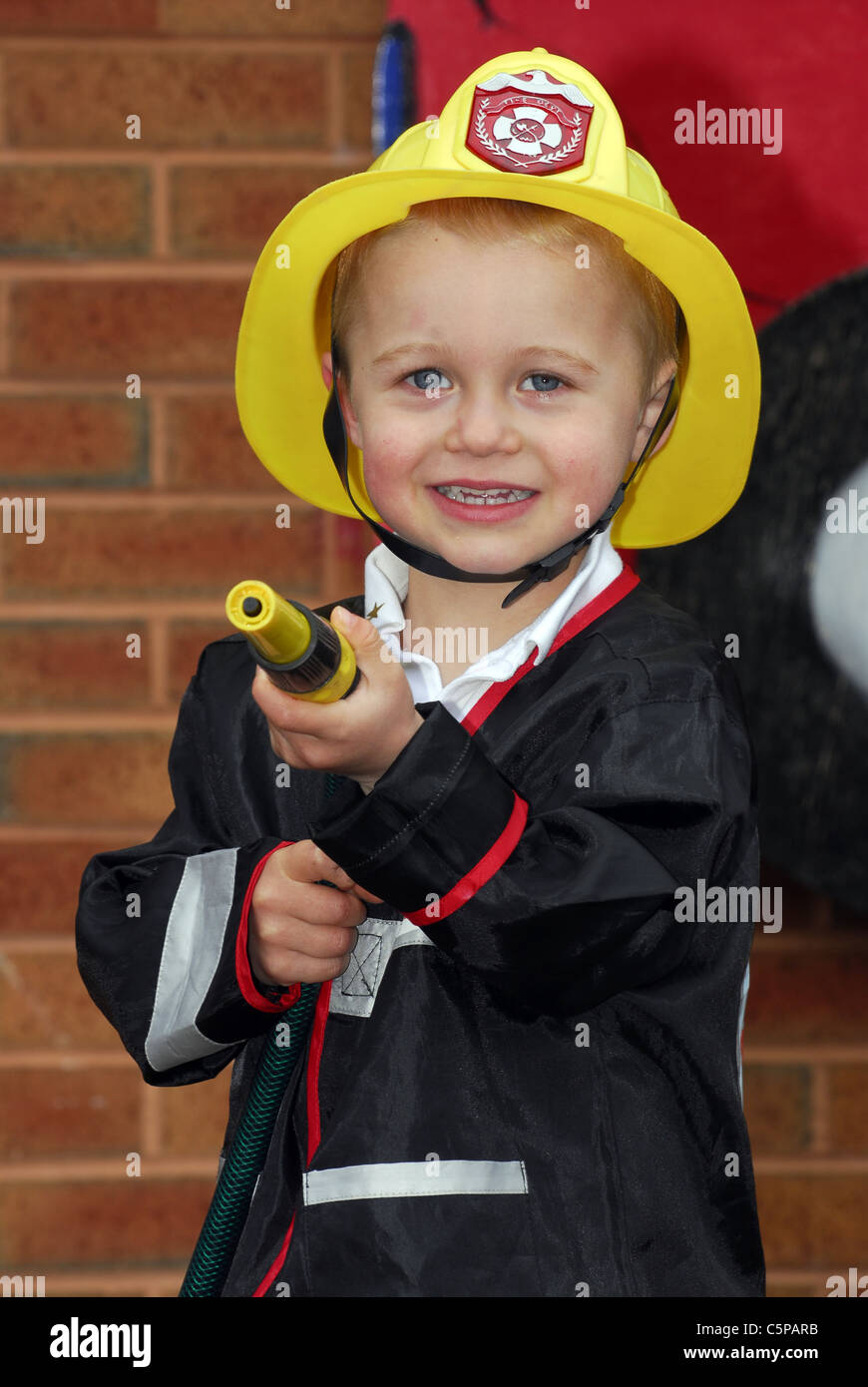 Young boy aspiring to be a fireman when he grows up, Liverpool, UK ...