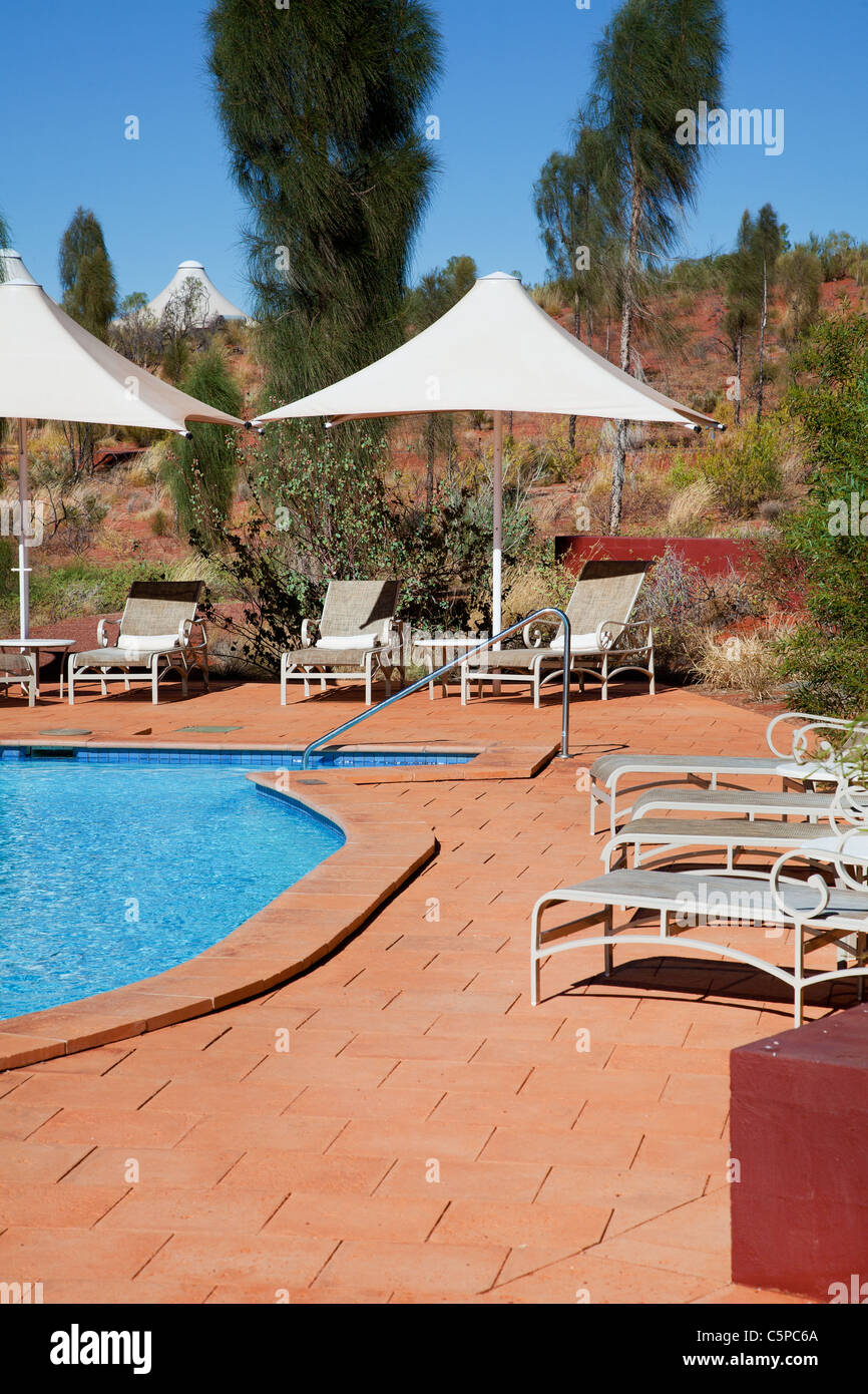Swimming pool with parasols ans sun loungers Stock Photo - Alamy