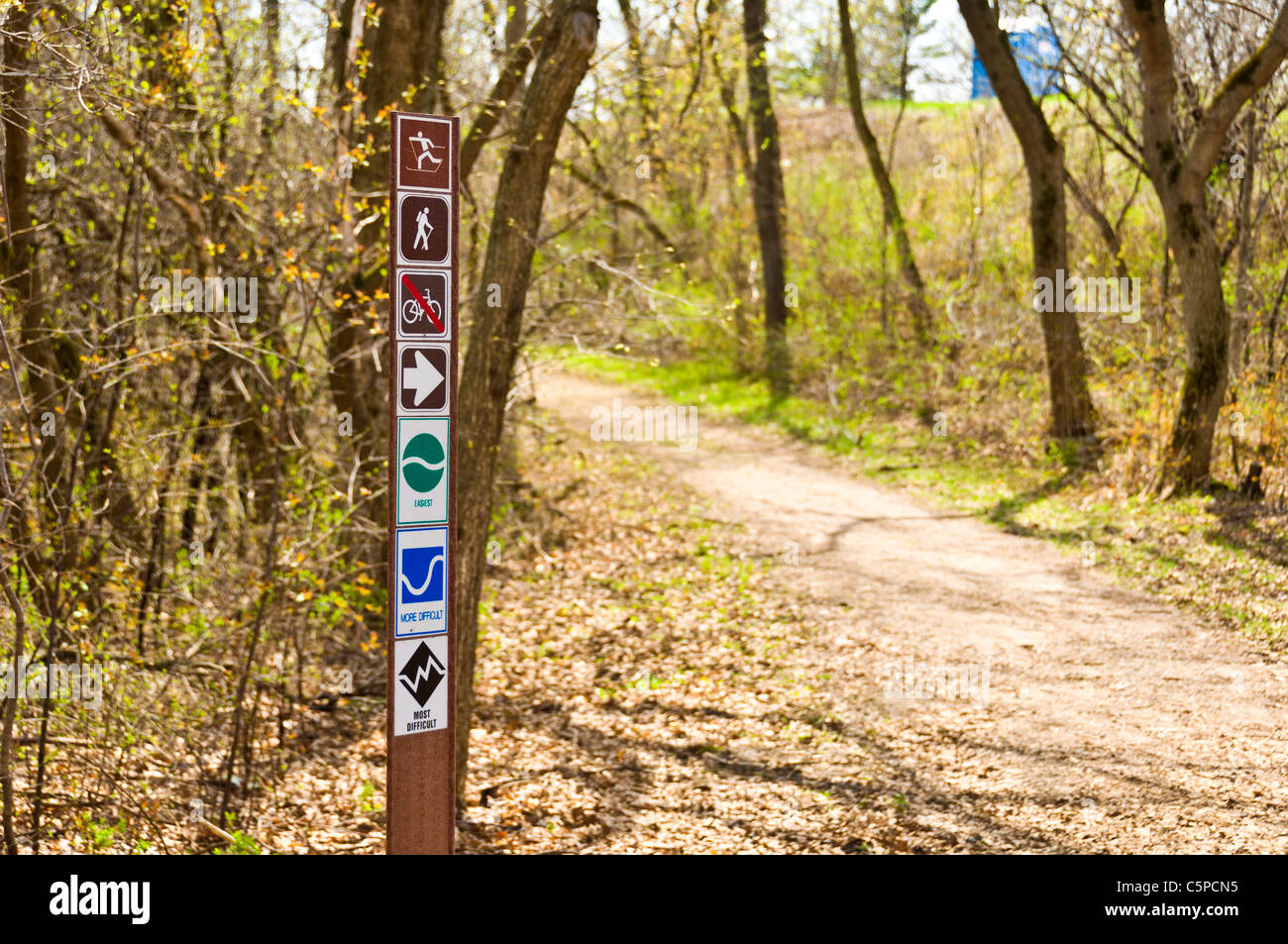 A Biking, Walking, and Hiking sign at the start of a Trail in the woods ...
