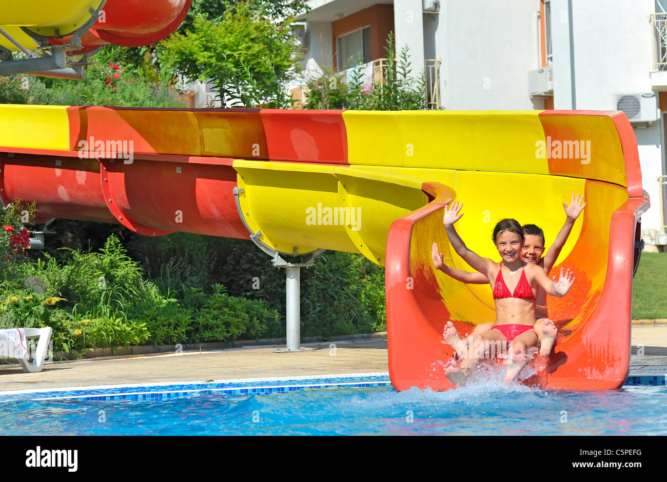 children sliding down a water slide Stock Photo - Alamy