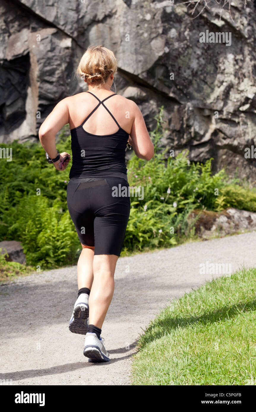 fat woman running around in the park, seen from behind Stock Photo - Alamy