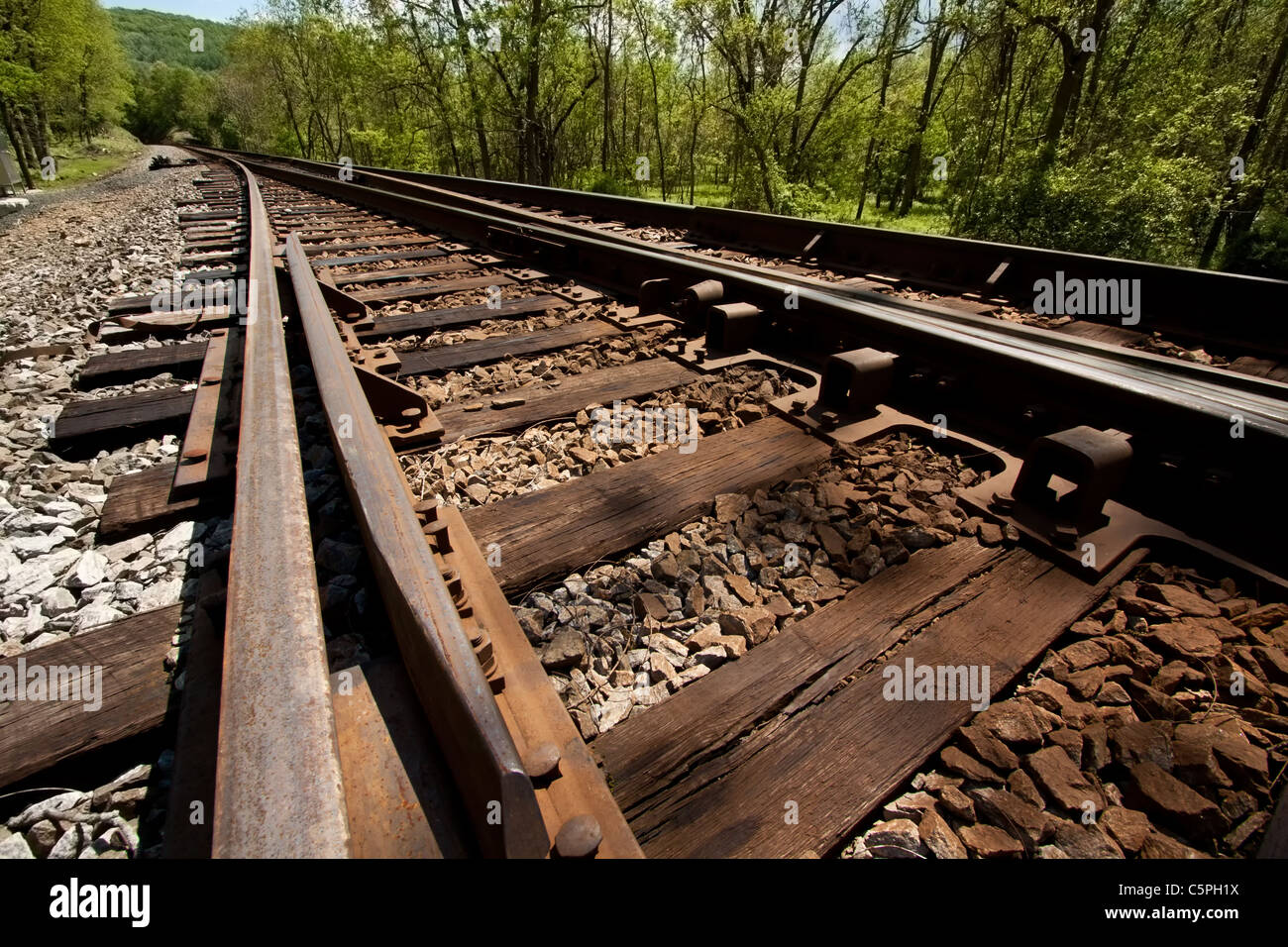 An angled view down railroad tracks in a country setting Stock Photo ...