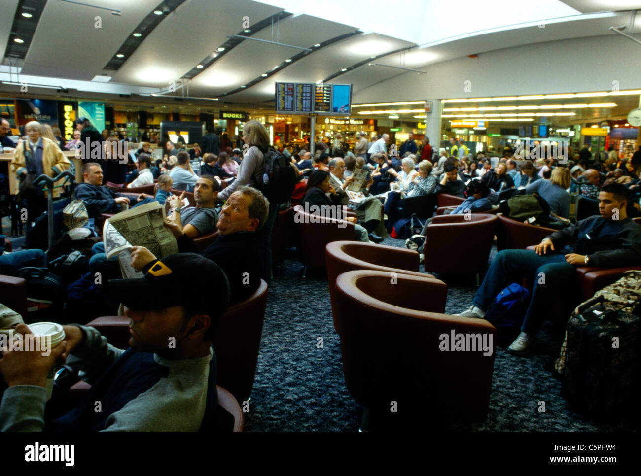 Heathrow Airport Terminal 3 Passengers In Busy Seating Area Stock Photo ...