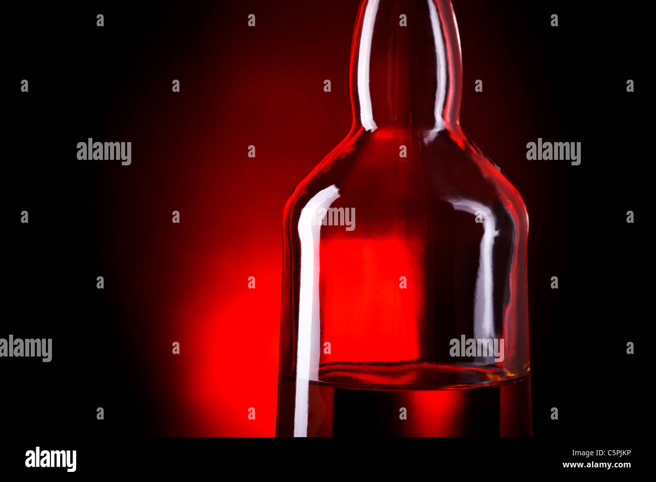 bottle of whiskey on deep red background Stock Photo - Alamy