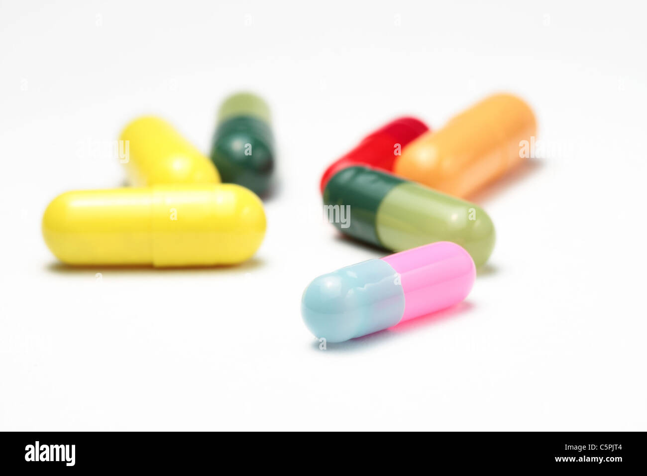Colorful capsules high key isolated on white Stock Photo - Alamy