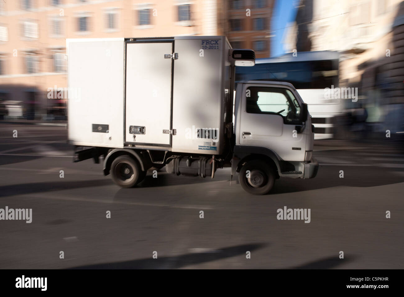 Delivery van running in the city street Stock Photo - Alamy