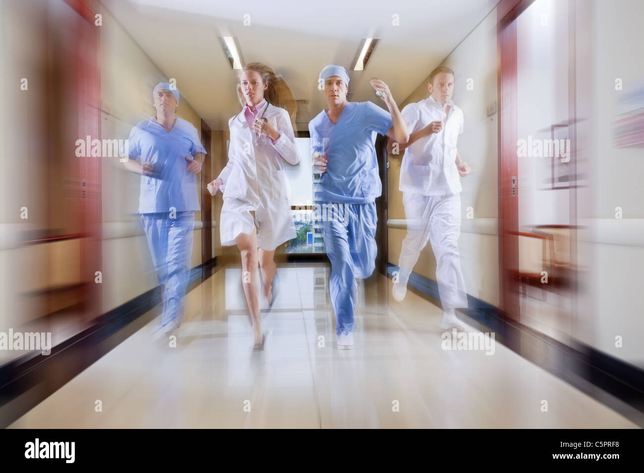 Surgeon and nurse running in hallway of hospital Stock Photo - Alamy
