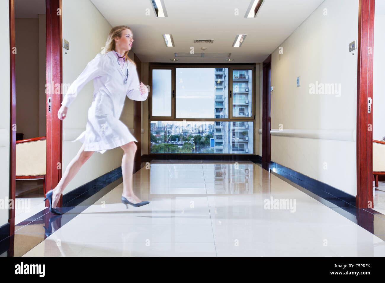 Female doctor rushing across the hallway in hospital Stock Photo - Alamy
