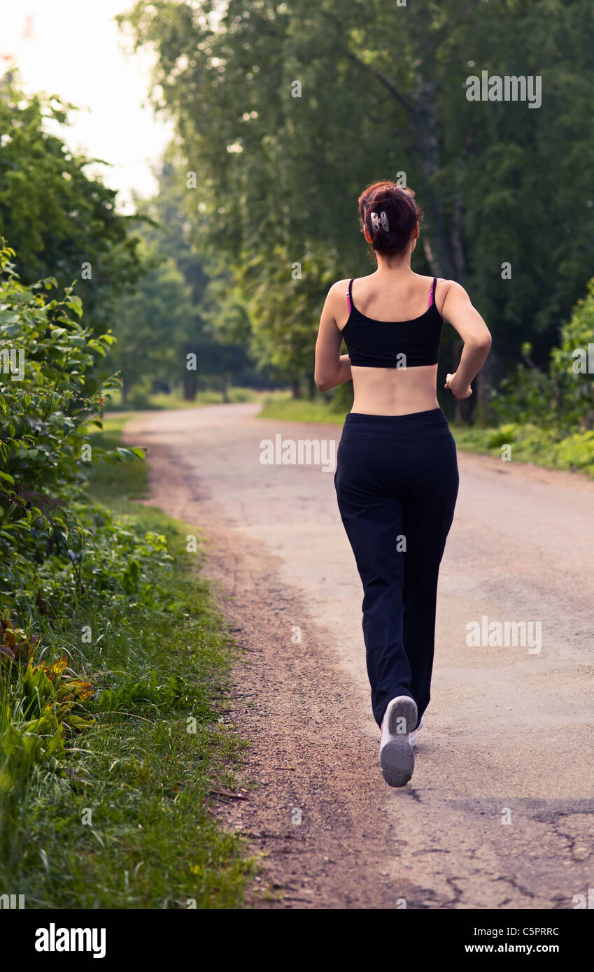 Morning run on rural road Stock Photo - Alamy